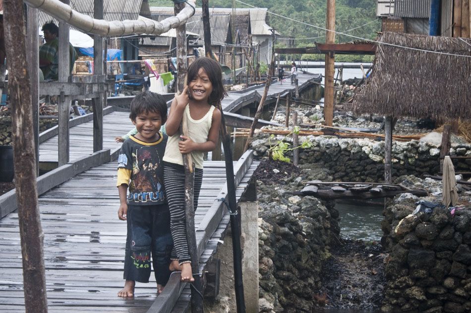 Children from Sampela, Indonesia, a "sea gypsy" community, playing on ...