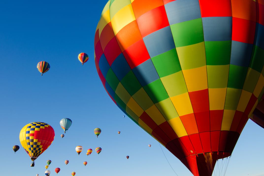 The first balloons take flight during the Albuquerque International ...