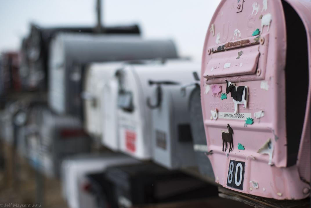 A pink mailbox stands out, among many others, in the high desert of ...