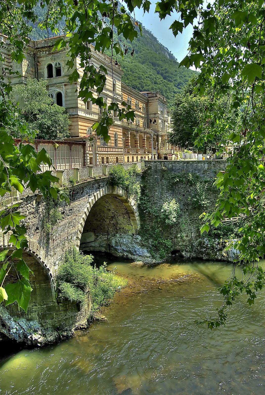 Romantic scene with a stone bridge and beautiful architecture ...