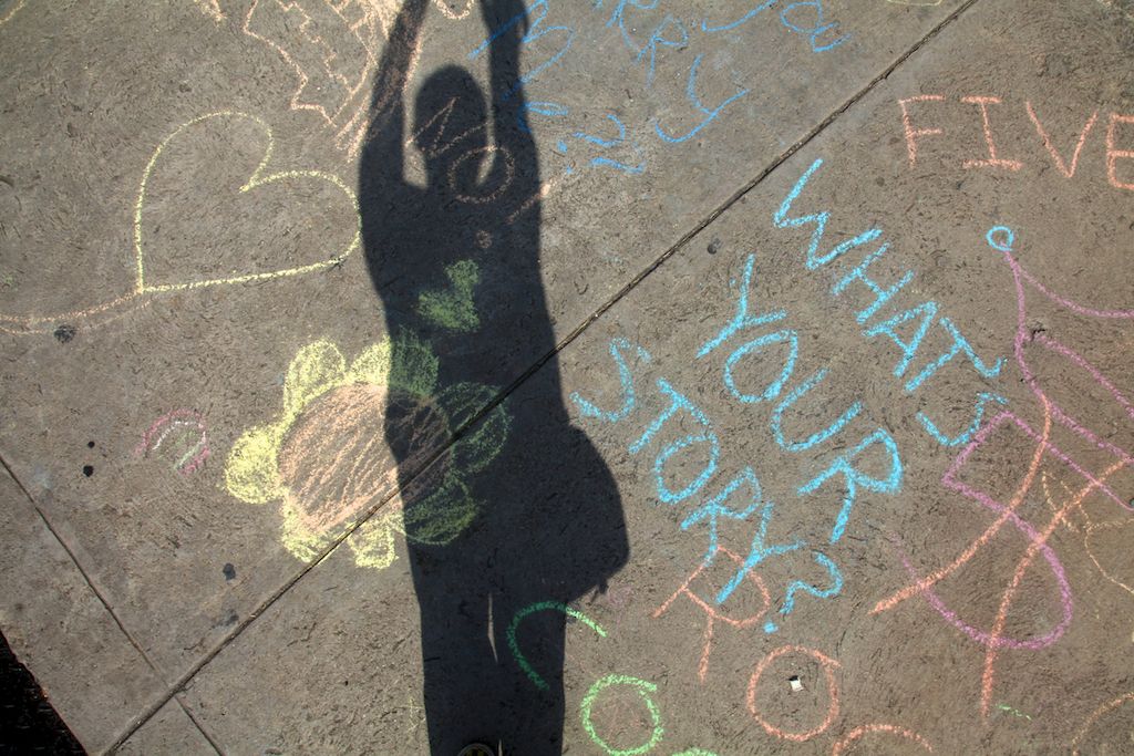 The shadow of the photographer passes over chalk drawings in Silverlake ...