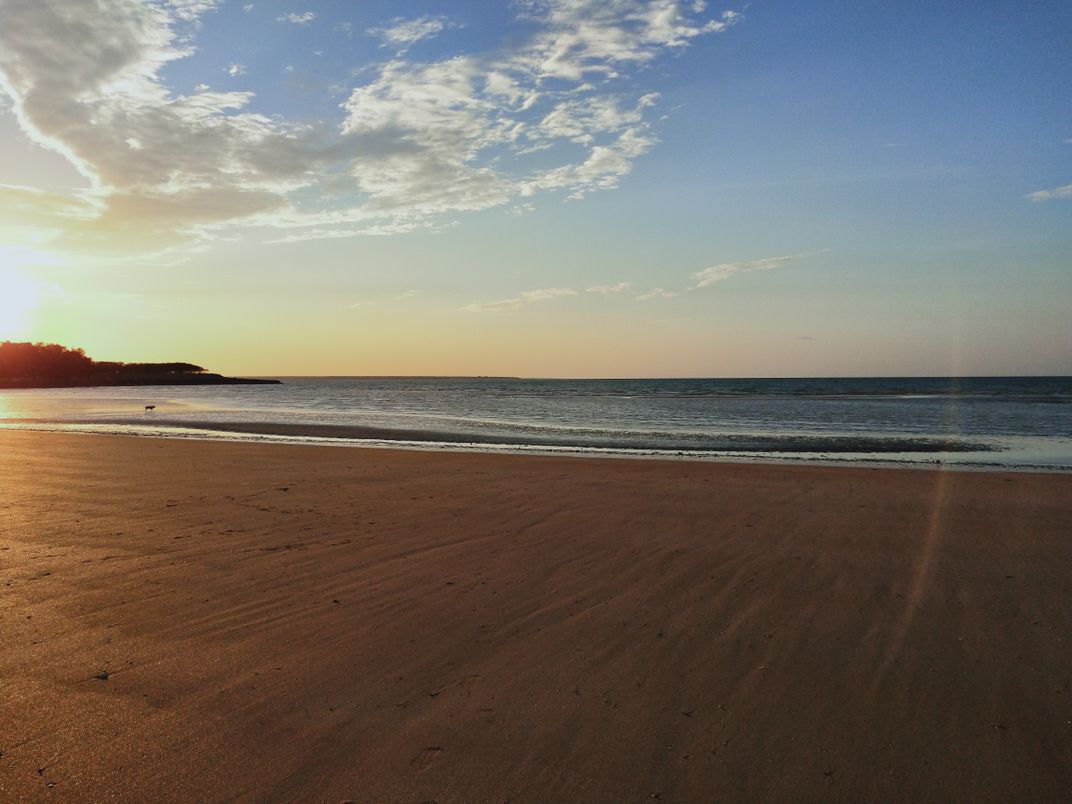 Sandy Beach with sea water with a majestic sunset | Smithsonian Photo ...