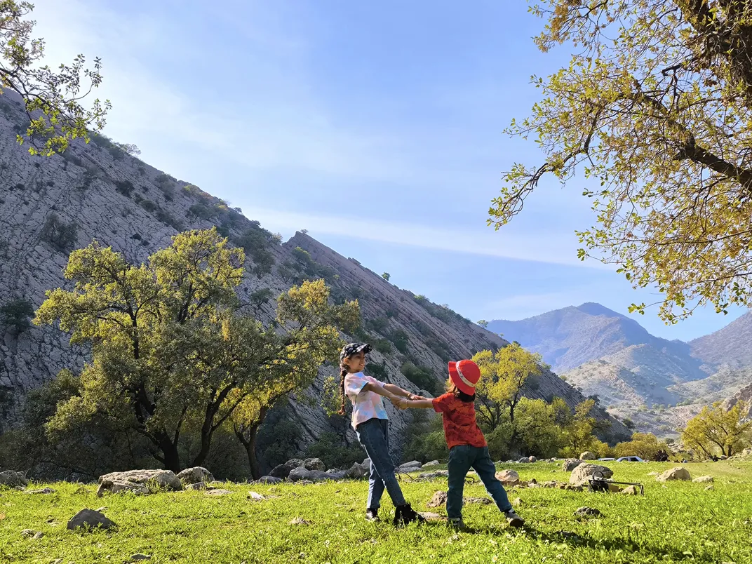 Children playing in the beautiful nature of the plains and mountains ...