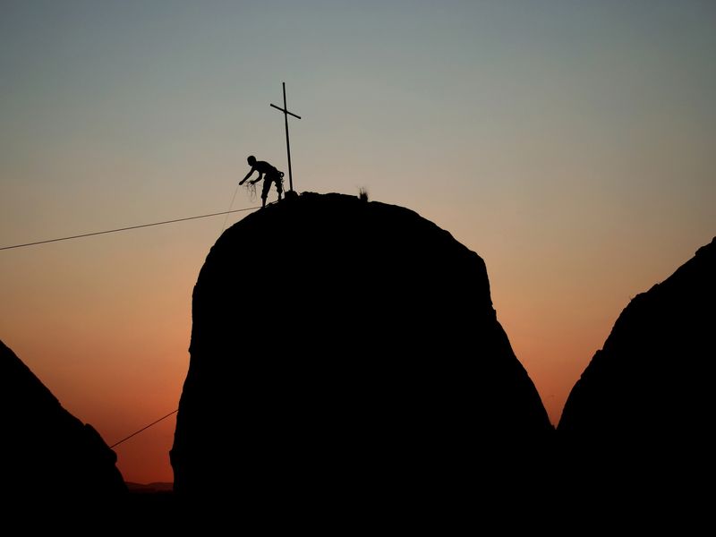 MAN ON TOP OF CLIFF, HOLDING A CROSS | Smithsonian Photo Contest ...