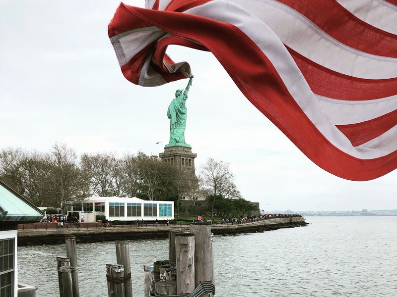 The Statue of Liberty with the American flag | Smithsonian Photo ...
