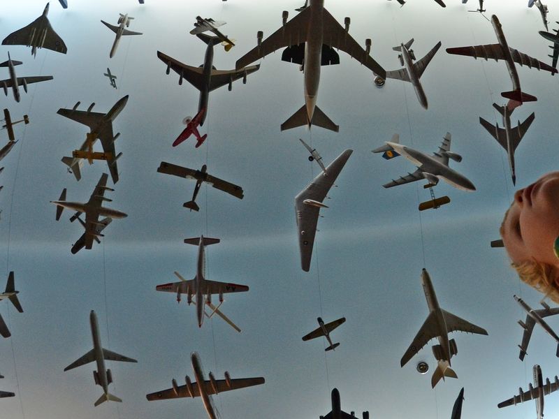 My son admiring the model planes hanging from the ceiling at the ...