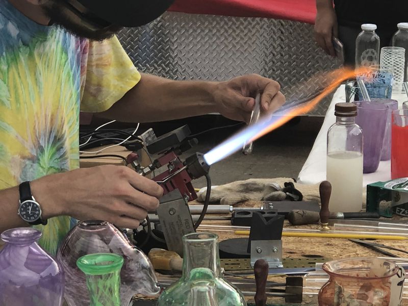 Glassblower with colors repeated in heat, glass, and clothing ...