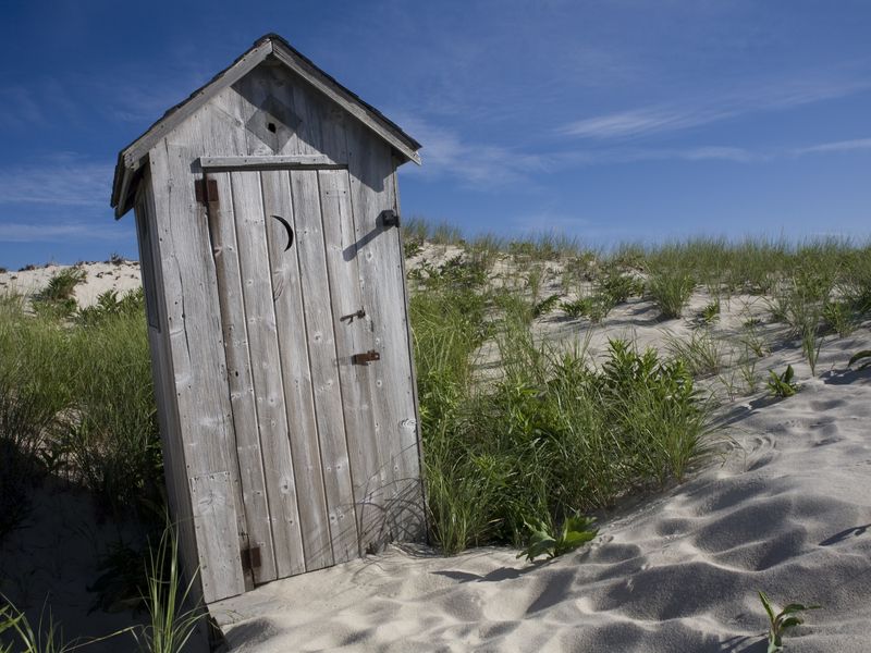 A weathered outhouse on the dunes of Cape Cod's barrier beach is slowly ...