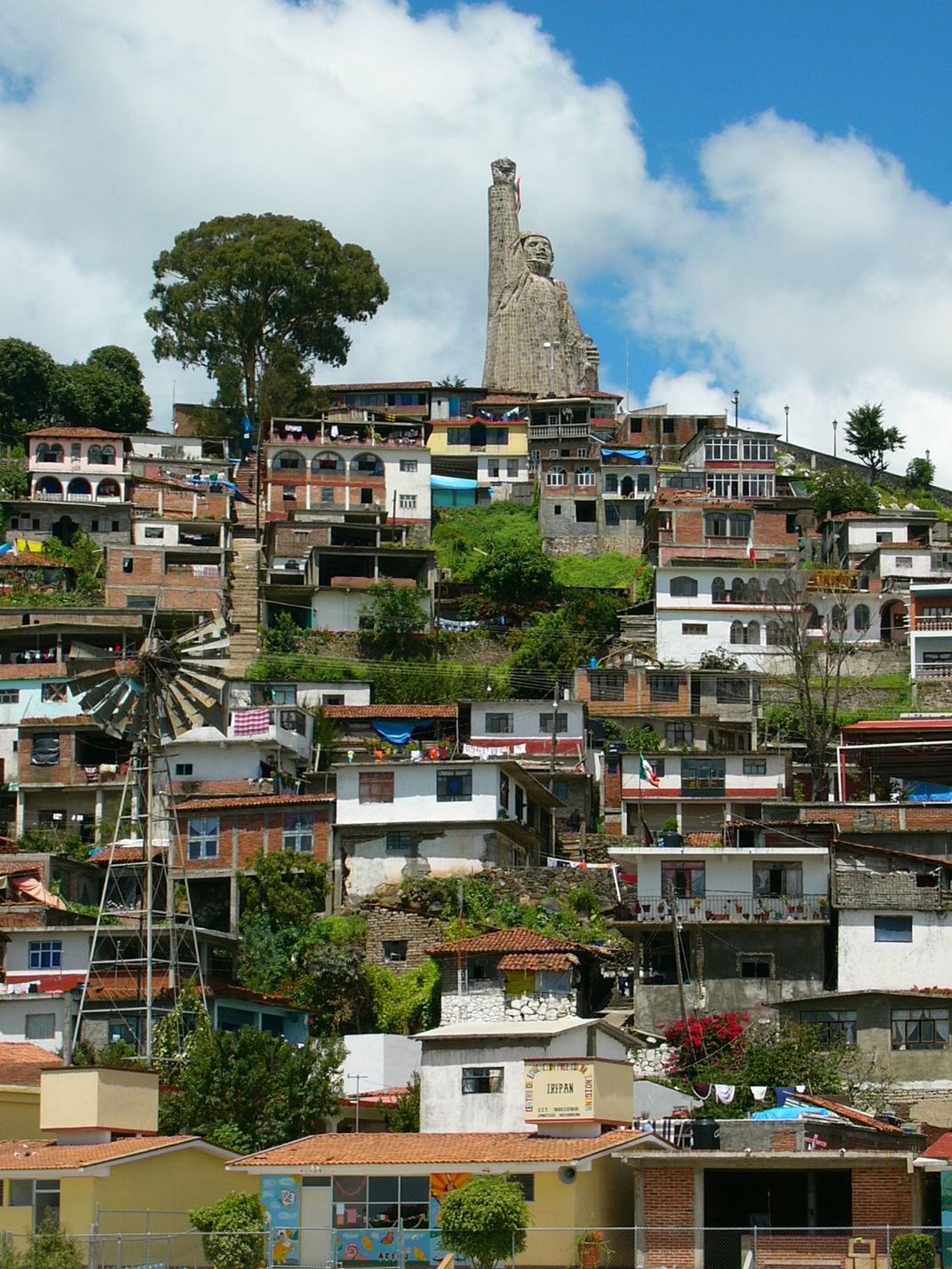 Statue of Jose Maria Morelos rising over the homes of Janitzio Island ...