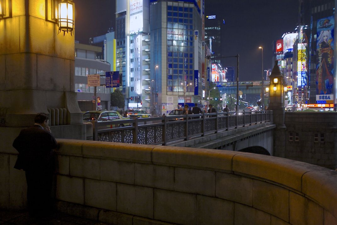 A man stops for a smoke looking over Mansei Bridge, a solemn reminder ...