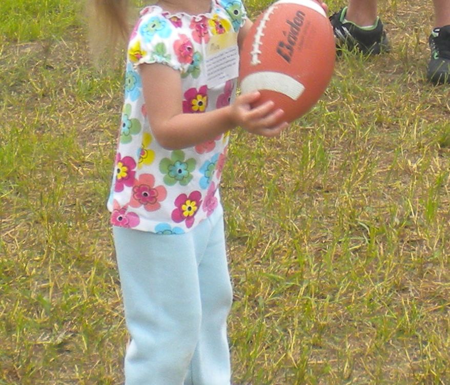 Little girl playing catch with a football | Smithsonian Photo Contest ...