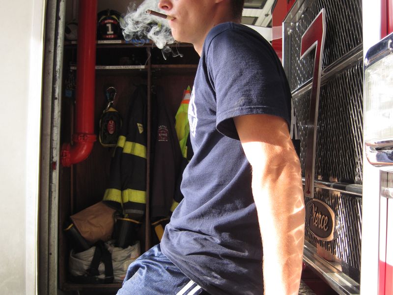 Volunteer firefighter smoking a cigar at the station | Smithsonian ...