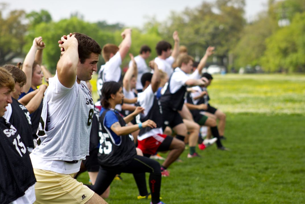 Rugby players start their day of skills camp by dynamic stretching ...