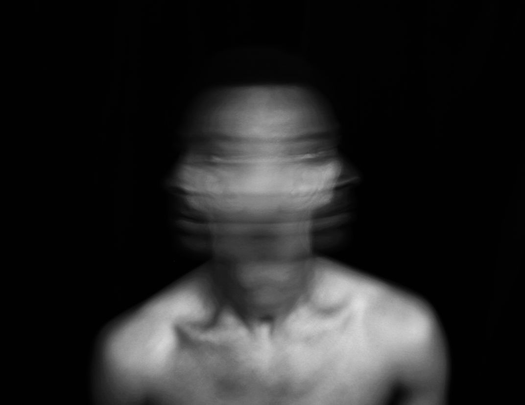 Man photographed in a studio while turning his head several times with ...