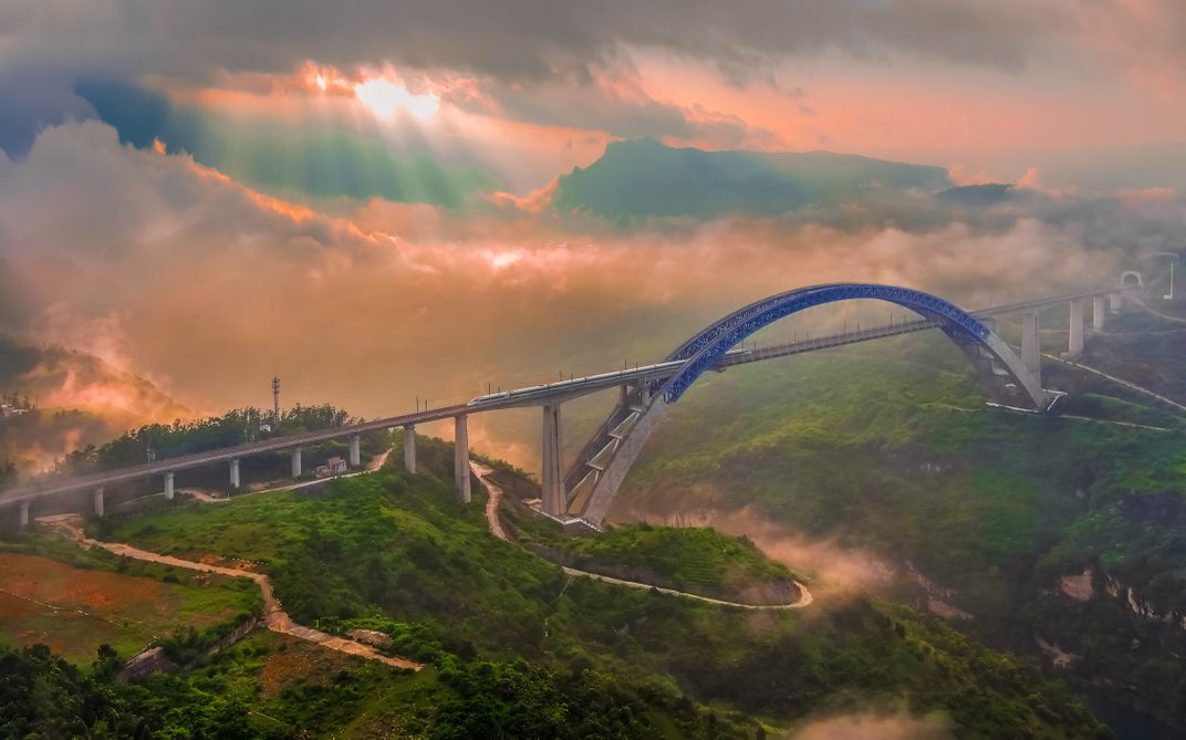 The glow of dawn shines on the high-speed railway bridge. | Smithsonian ...