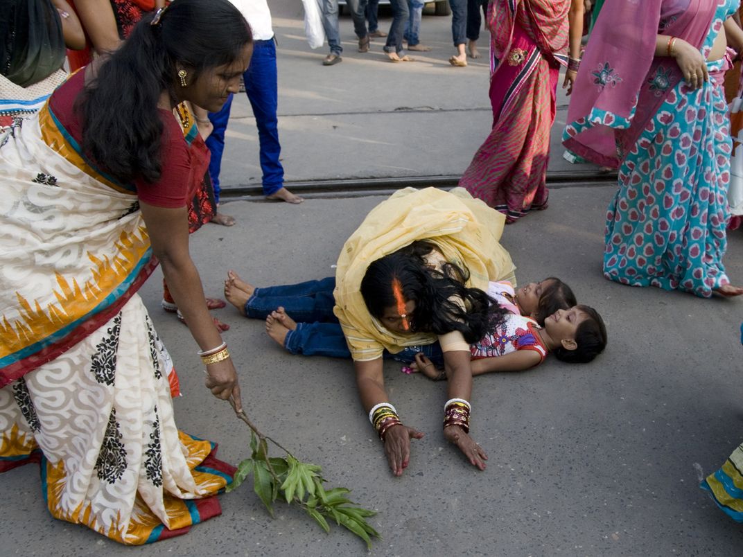 The woman is performing a Hindu ritual in the faith of God and she ...