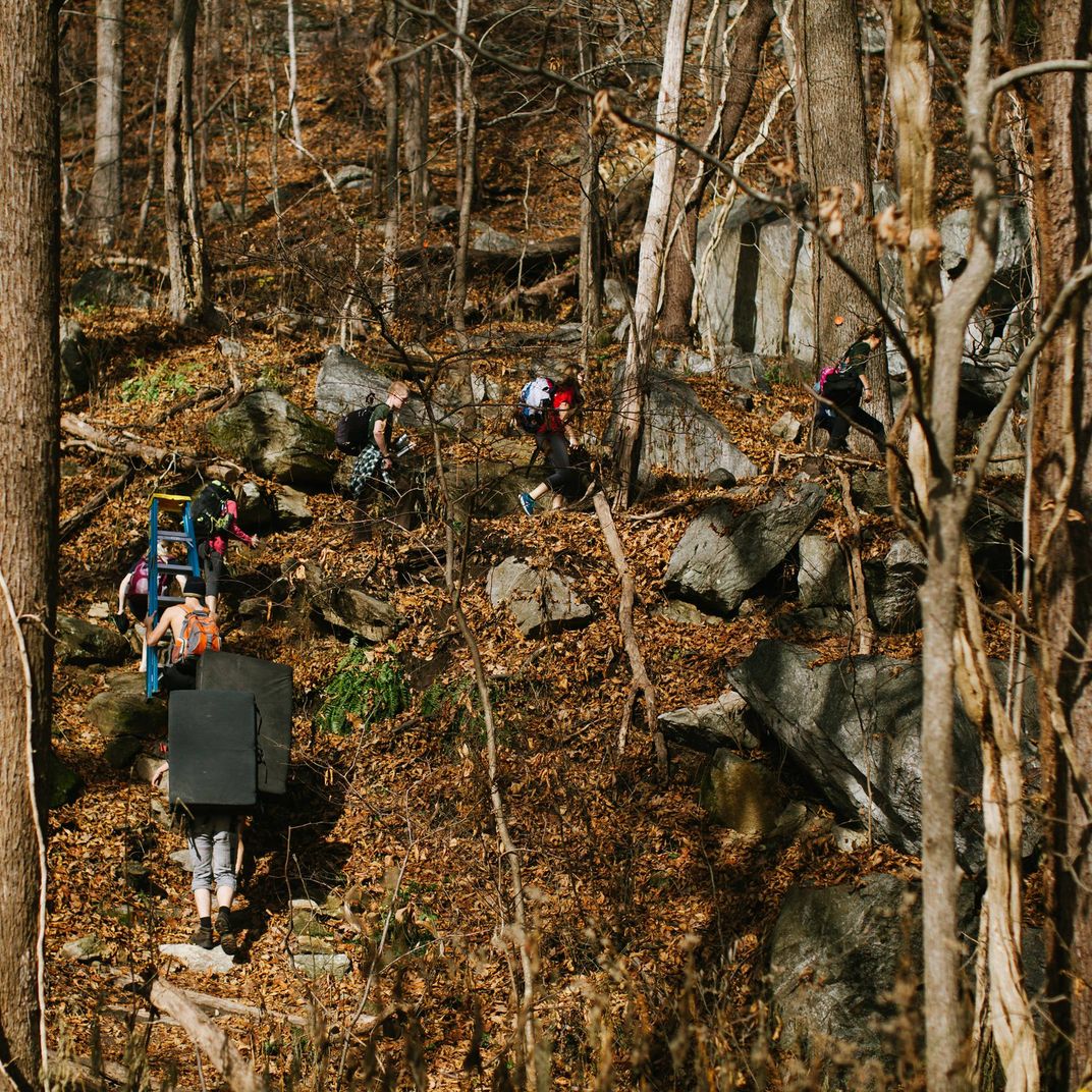 Hiking up to boulders to climb in Rumbling Bald, North Carolina. All of ...