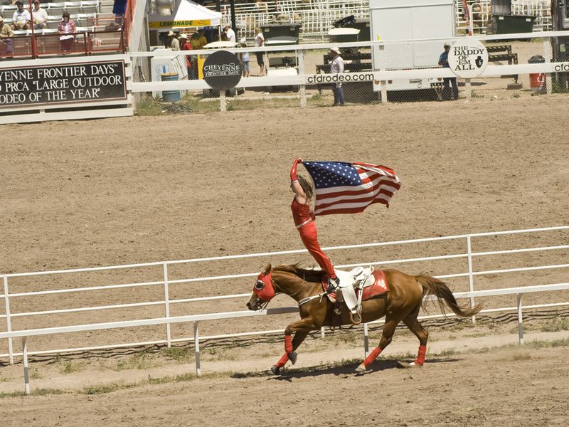 A trick rider flies the American flag at the Cheyenne Frontier Days ...