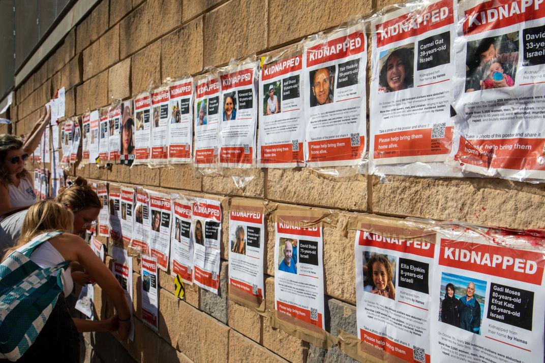 Women stick posters of hostages in the defense ministry | Smithsonian ...