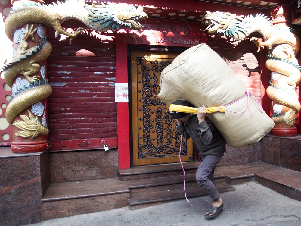 The man is carrying a huge sack. | Smithsonian Photo Contest ...