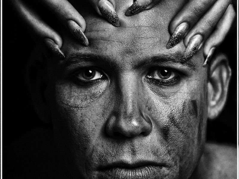 Female hands pushing down a male's sad head. | Smithsonian Photo ...