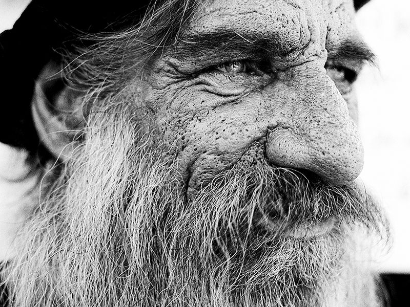 A timeless gaze frozen on his weathered face suggests harsh living or ...