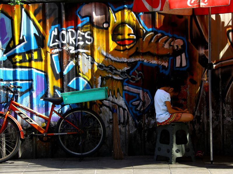Child sleeping in front of graffiti wall | Smithsonian Photo Contest ...