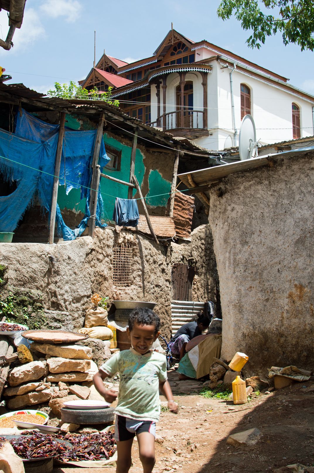 A curious boy running towards the "faranji"-photographer in old town of ...