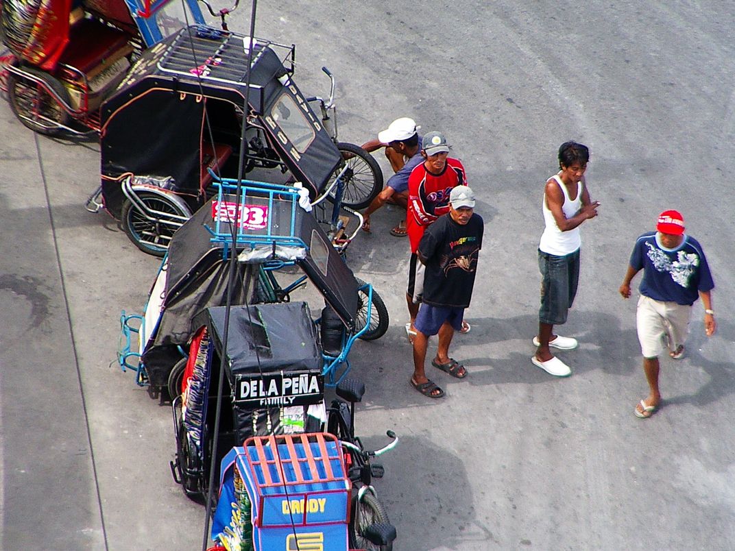 Tricycle drivers wait for customers outside Crowne Bay Tower condos on ...