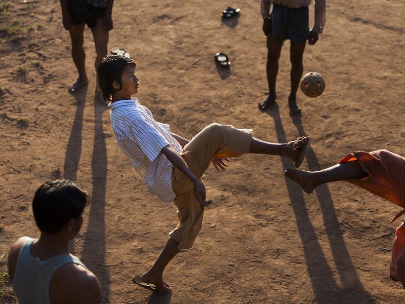 Young mahouts (elephant riders), playing Chinlone, the traditional ...