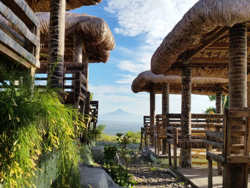 Mount Matutum from a distance and in between the cottages ...