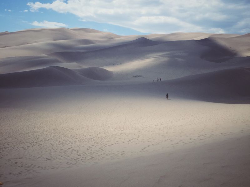 Trekking a dune field at Great Sand Dunes National Park and Preserves ...