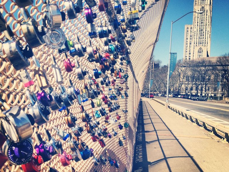 Love locks on the Schenley bridge fence with the Cathedral of Learning ...