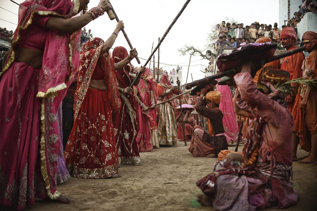 Women beat men with sticks during Holi Festival | Smithsonian Photo ...