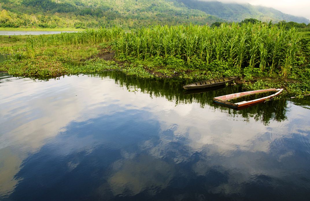 The sky reflects on the surface of Lake Selorejo, Malang, Indonesia ...