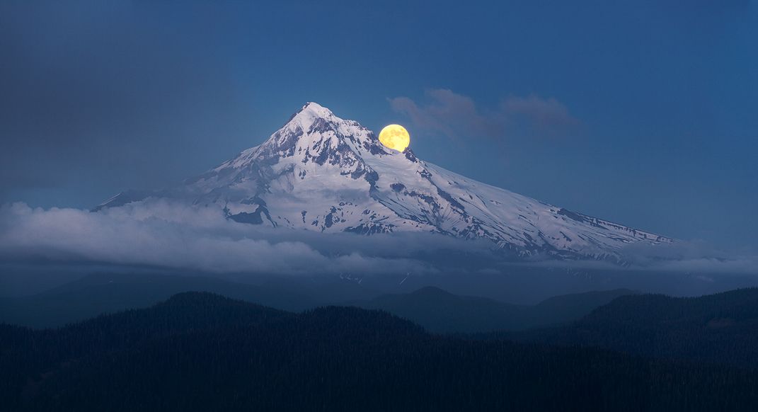 Lovely summer's full moon rises over Illumination Point on snow-clad Mt ...