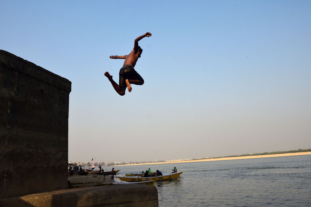 Boy jumping off a high pier at the Shivala Ghat | Smithsonian Photo ...