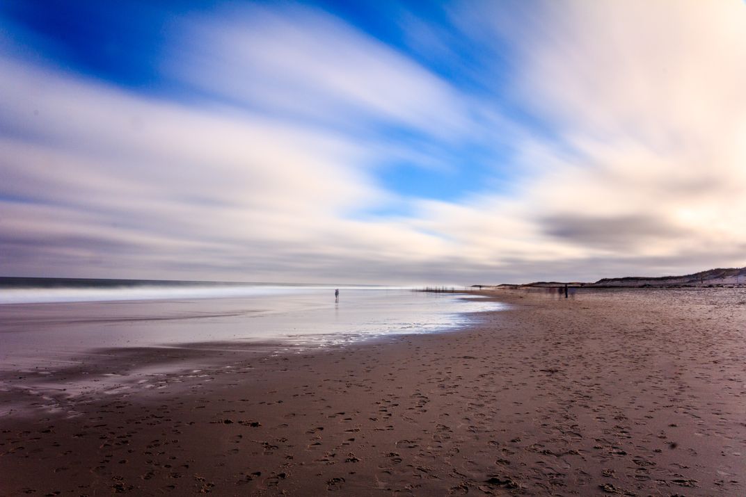 Long exposure of clouds and ocean on the beach in Cape Cod ...