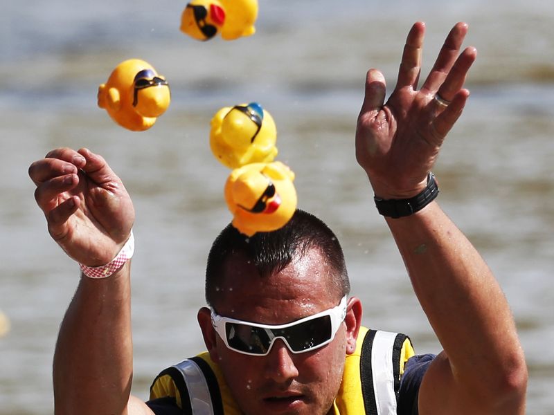 A worker puts some of the Rubber Ducks out of the Ohio River after the ...