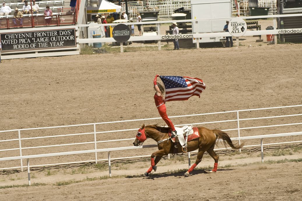 A trick rider flies the American flag at the Cheyenne Frontier Days ...