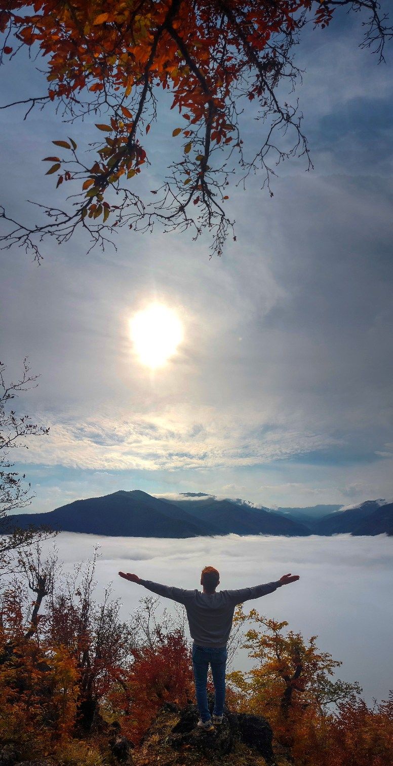 Dreaming of flying above the clouds like a free bird with open wings ...