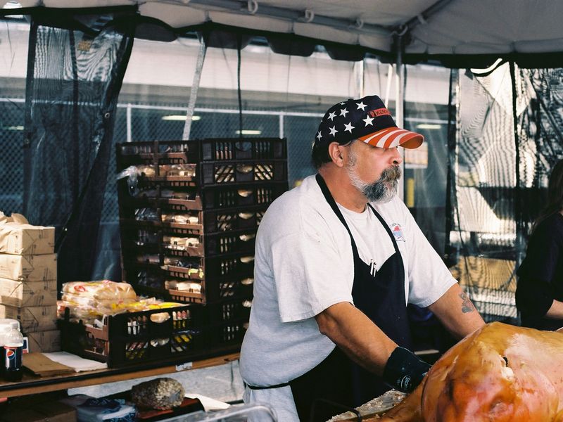A BBQ Pit Master attends his stand at a BBQ, Bourbon, & Blues festival ...