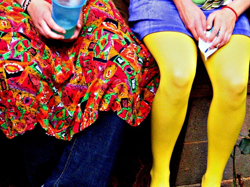 sitting on a porch with brightly colored, mismatching clothes ...